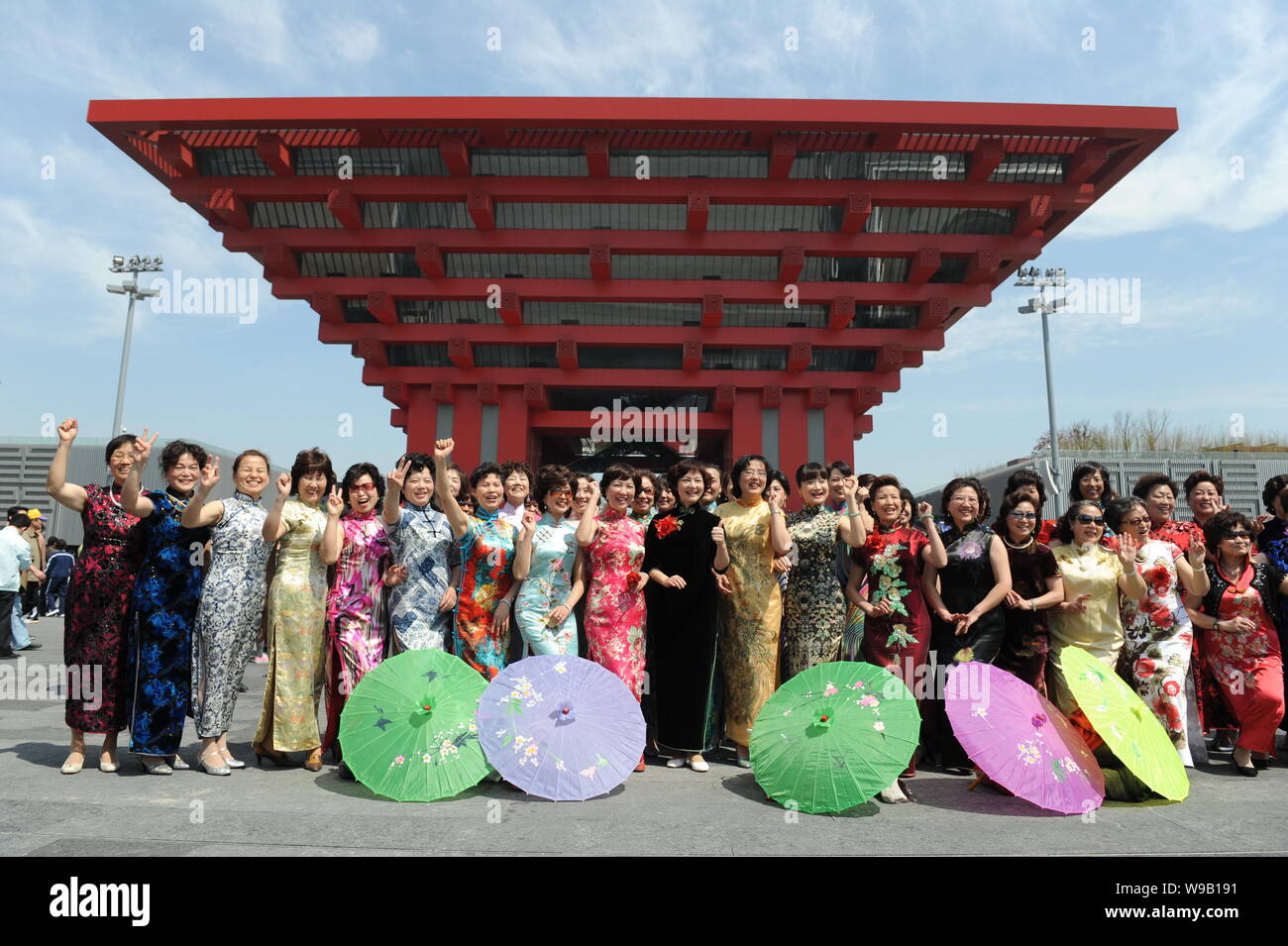 Chinese women wearing Qipao pose in front of the China Pavilion during ...