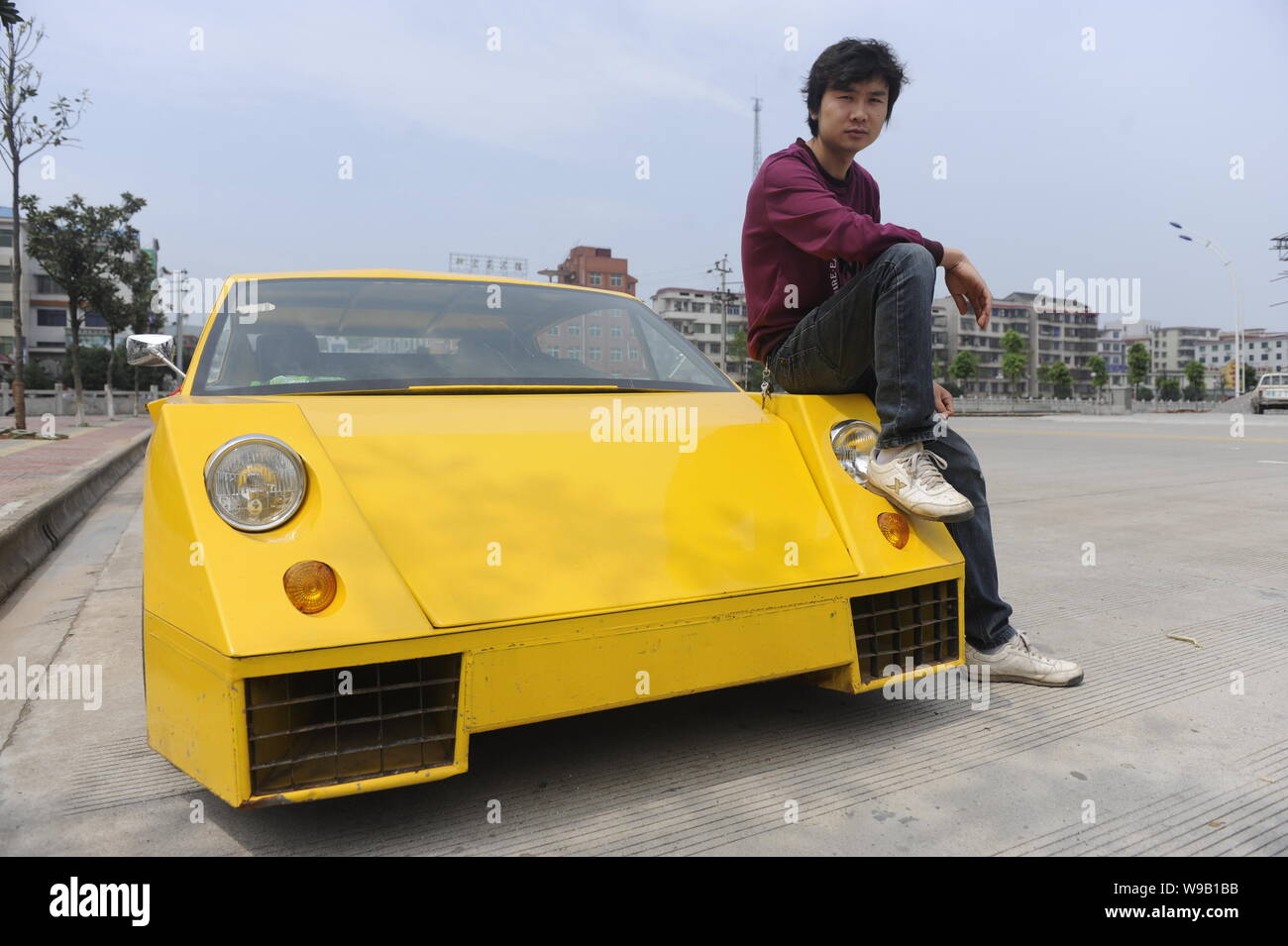 Chen Jinmiao sits on his knockoff Lamborghini by a street in Chenzhou ...