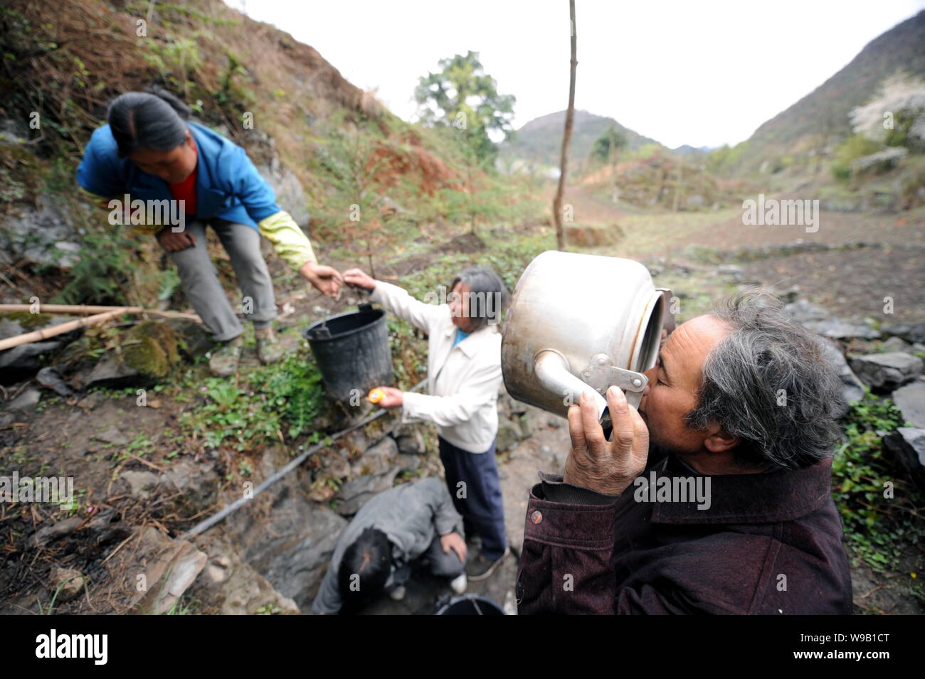 A villager drinks water that just fetched from a cave during a severe ...