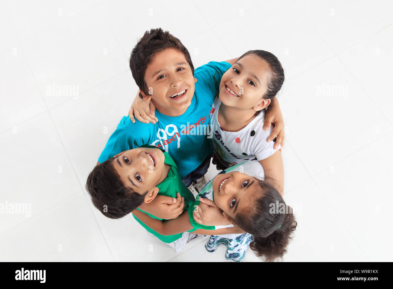 Group of friends smiling in a huddle Stock Photo - Alamy
