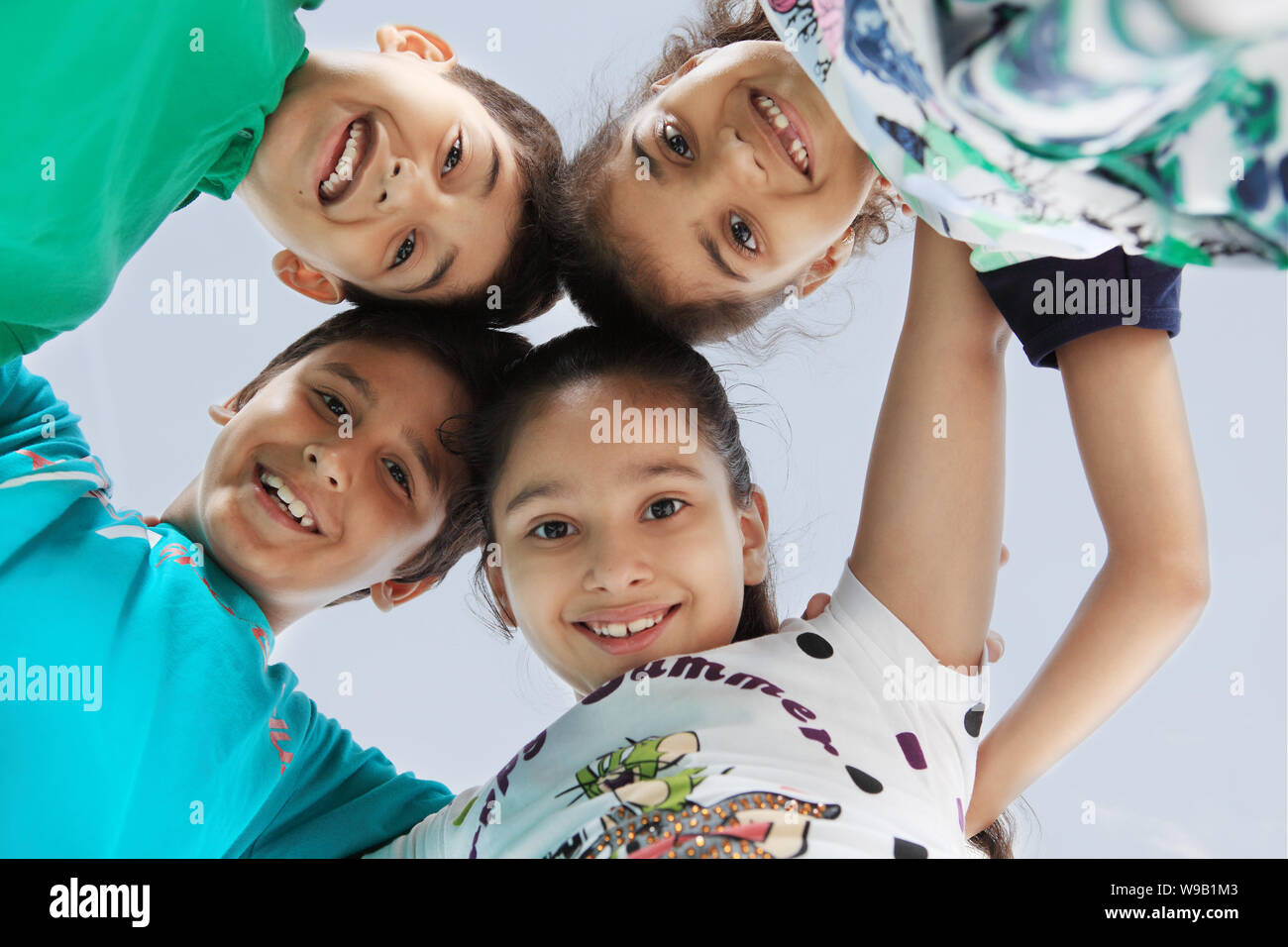 Group of friends smiling in a huddle Stock Photo - Alamy