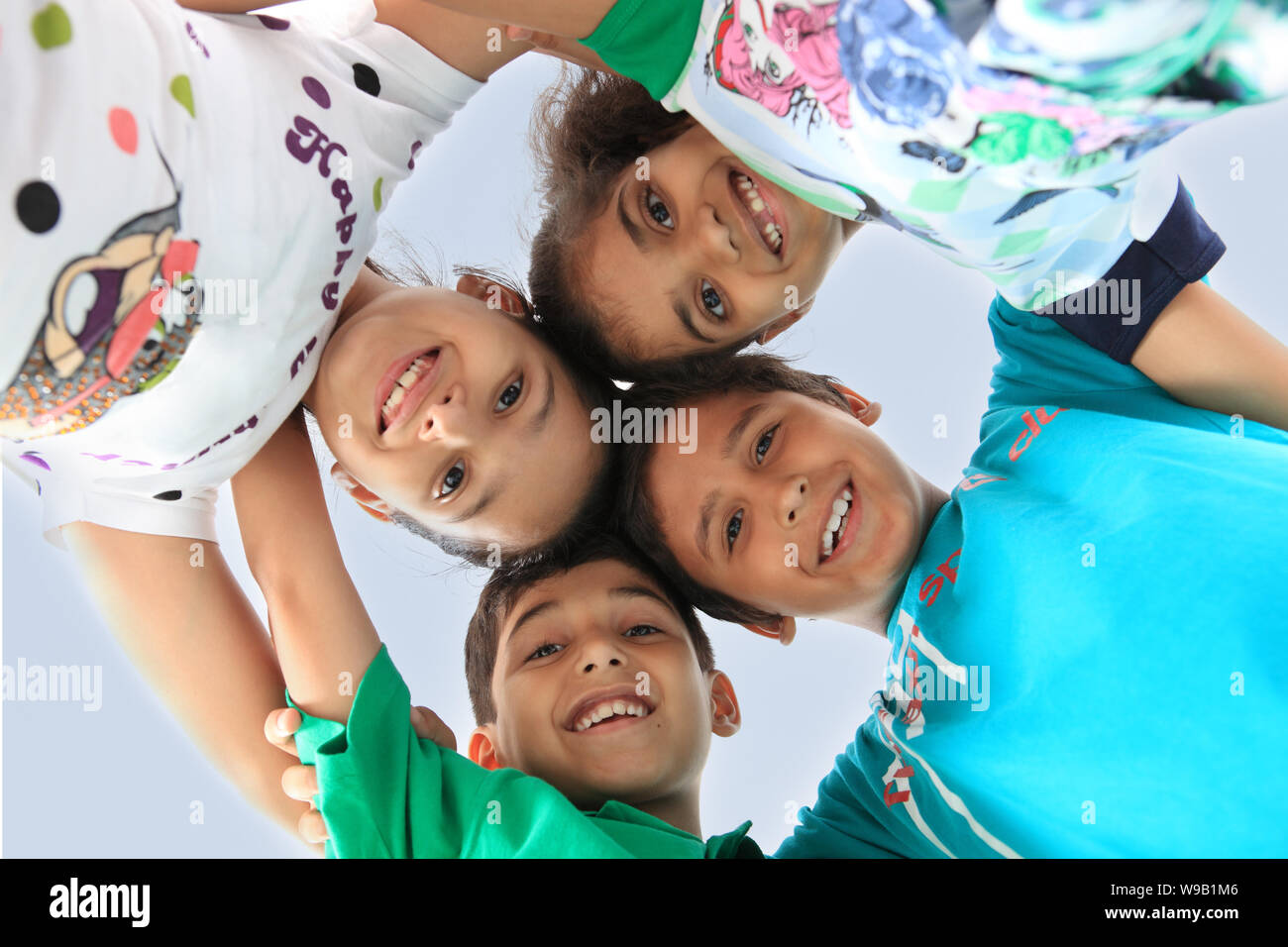 Group of friends smiling in a huddle Stock Photo - Alamy