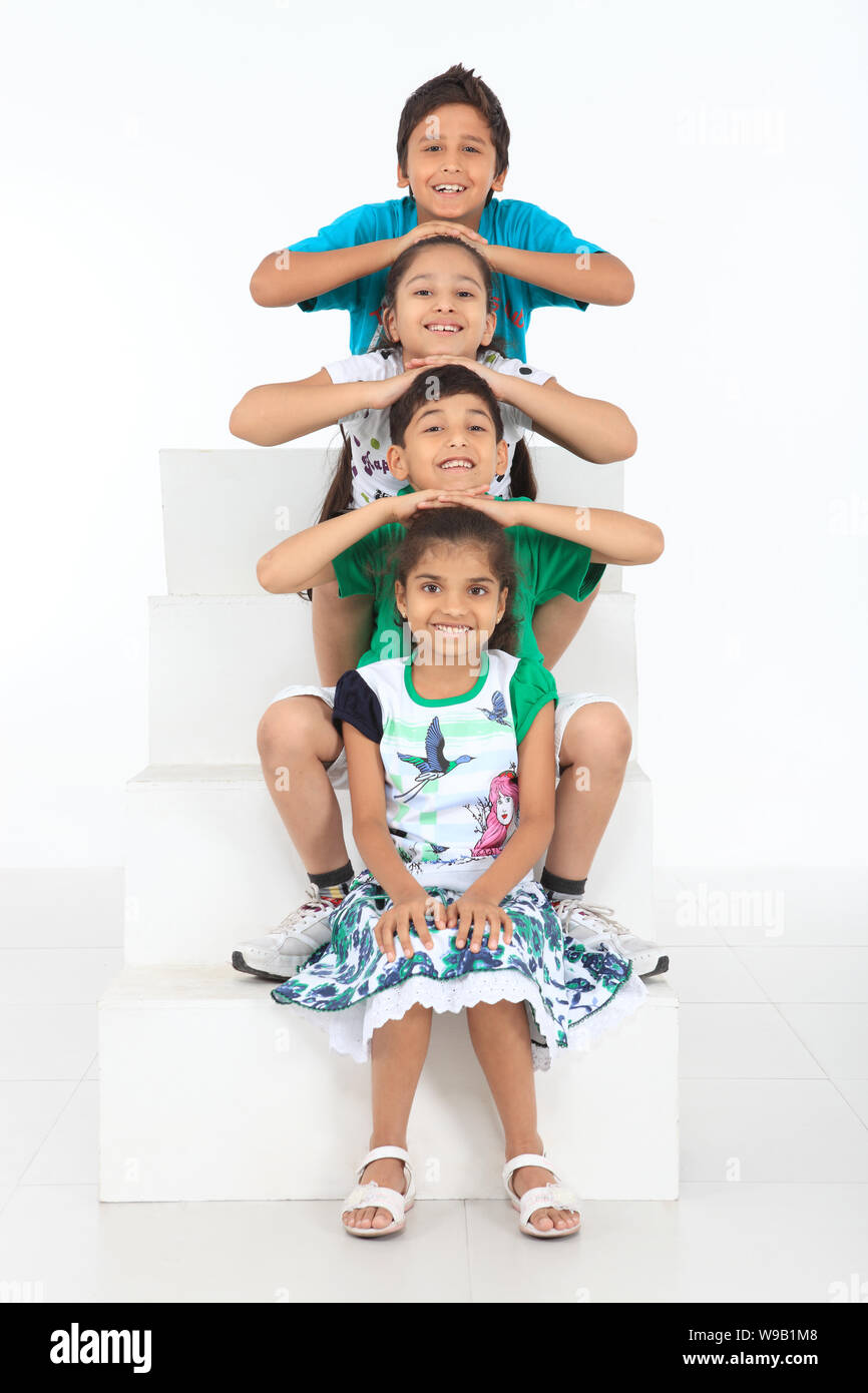 Group of children sitting in a queue Stock Photo - Alamy