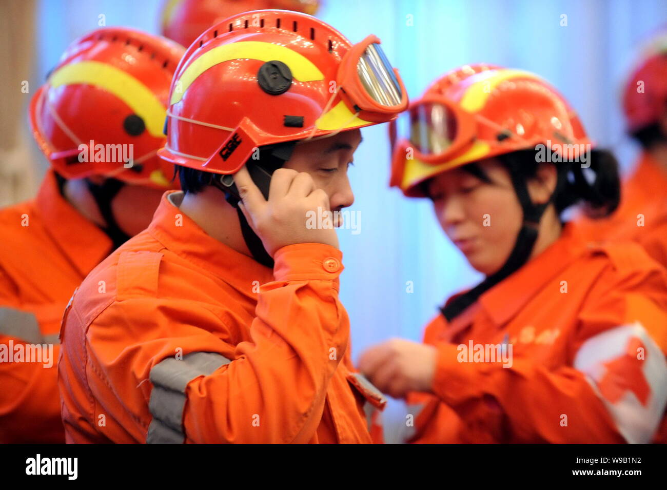 A Chinese rescuer talks on his mobile phone before leaving for quake ...