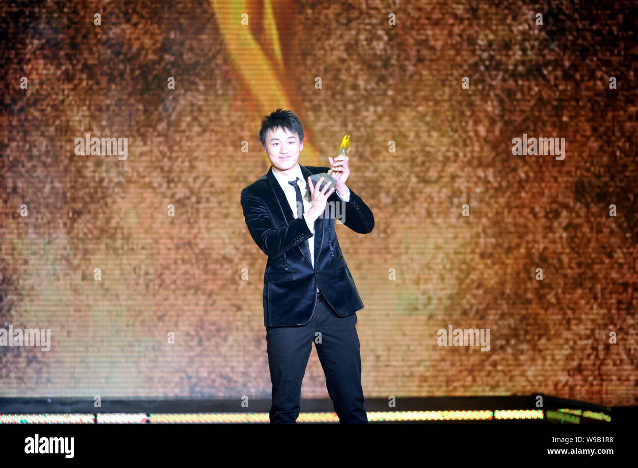 Chinese swimming champion Zhang Lin holds the trophy of the Best Male ...