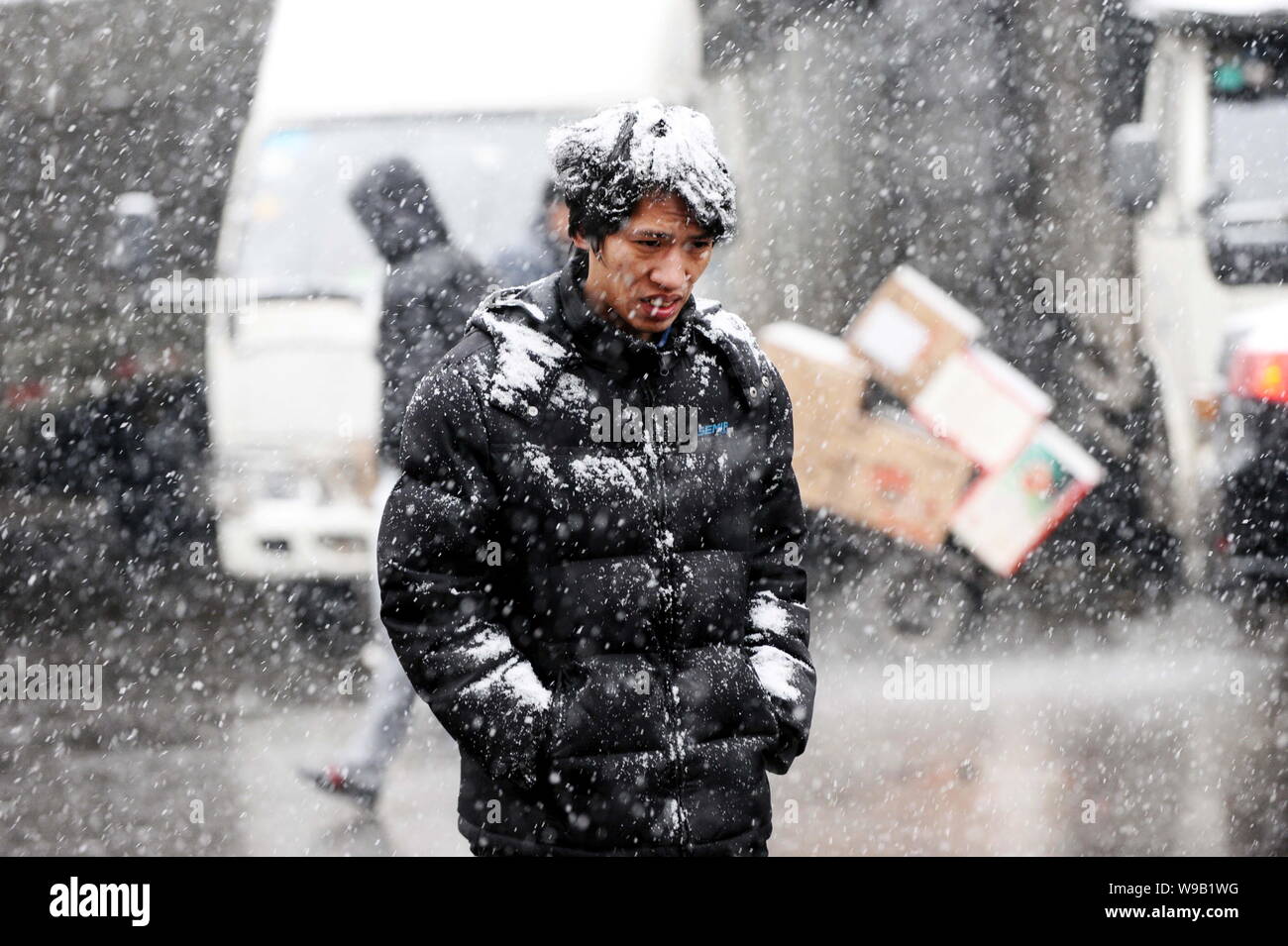 Chinese residents walk in a heavy snow in Wuhan city, central Chinas ...