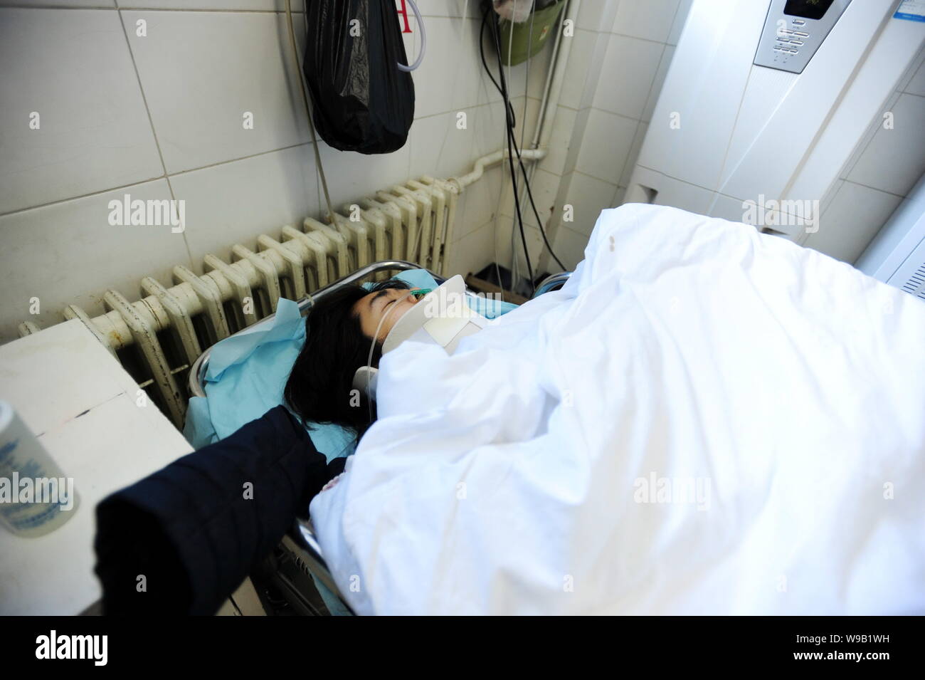 A woman receives medical treatment at a hospital after surviving the ...