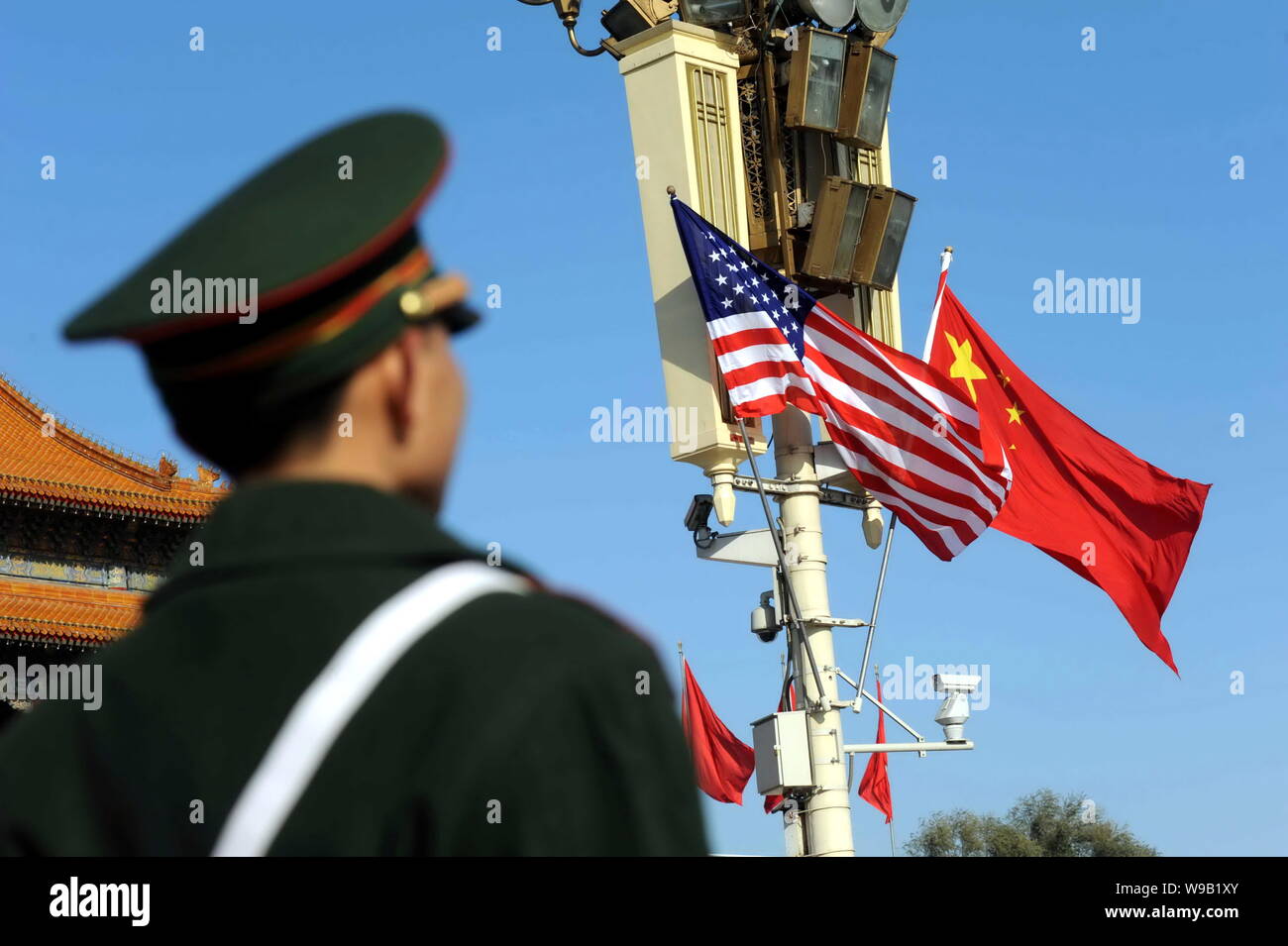 --FILE--A Chinese paramilitary policeman stands guard in front of a ...