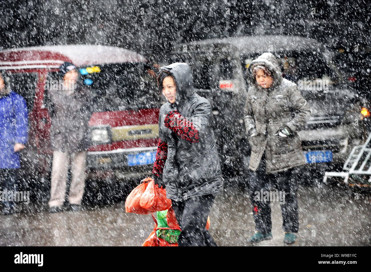 Chinese residents walk in a heavy snow in Wuhan city, central Chinas ...