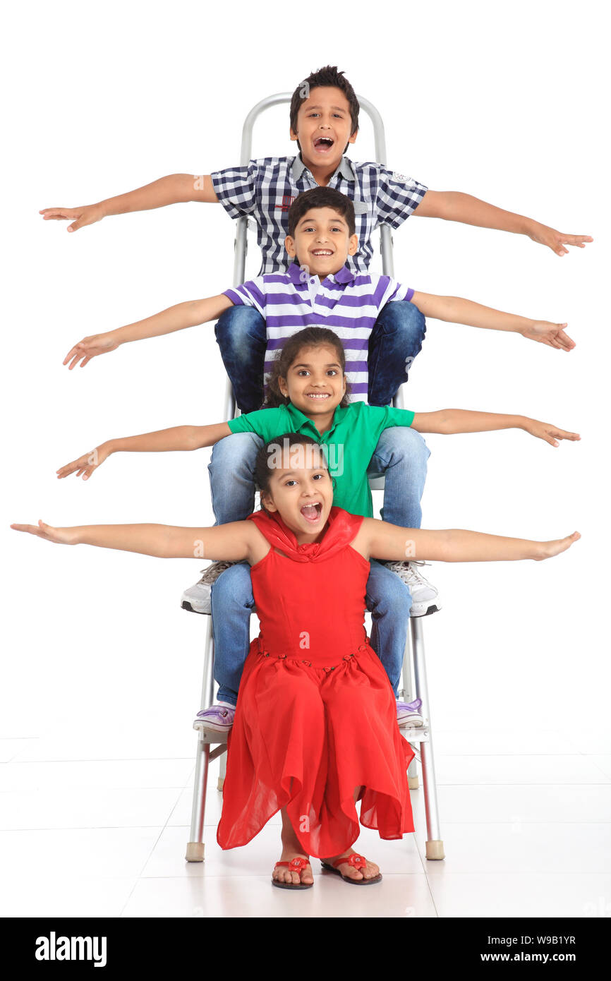Group of children sitting in a queue Stock Photo - Alamy