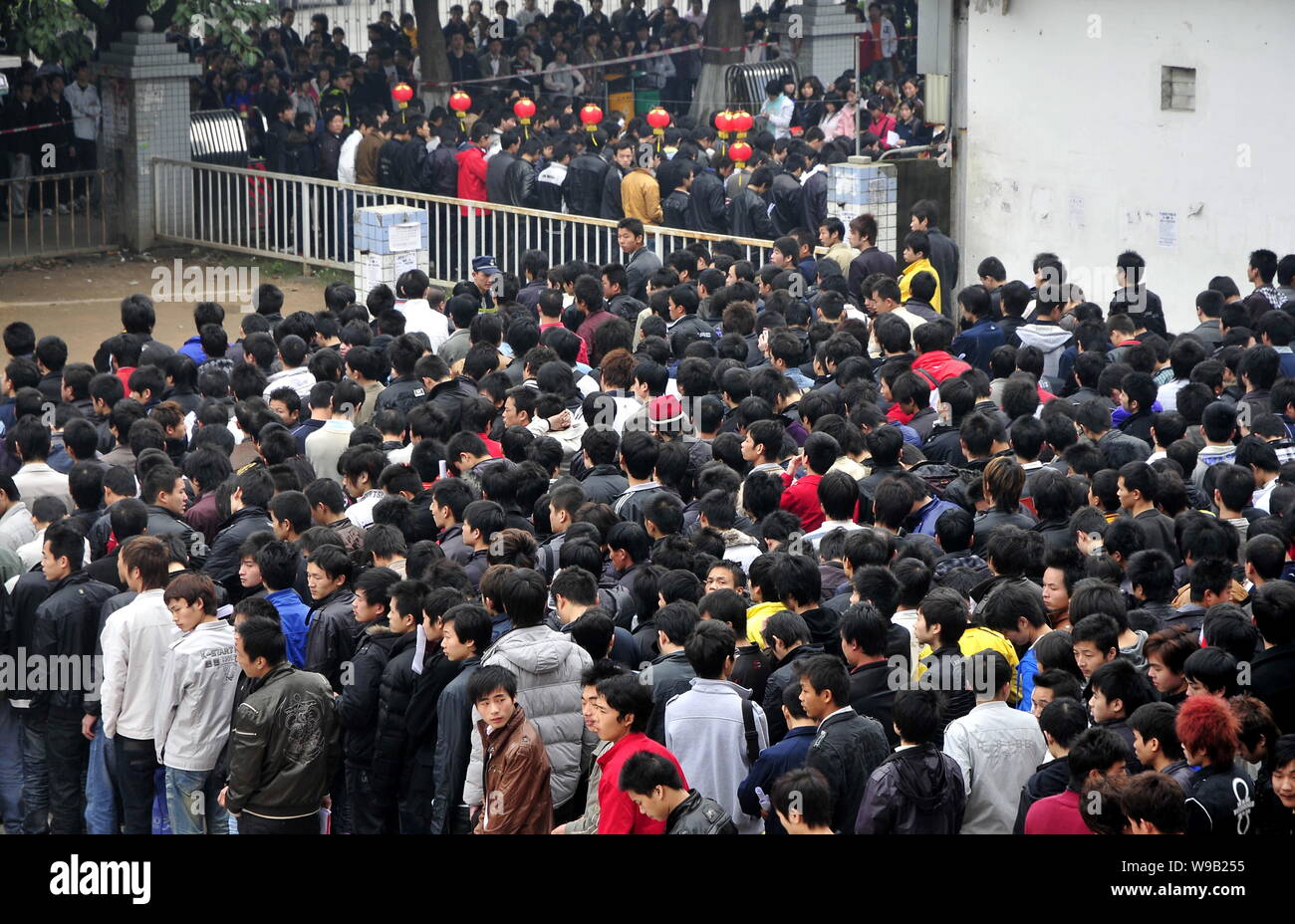 Crowds of job seekers queue up to apply for jobs during a recruitment ...