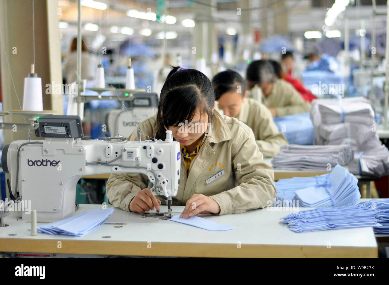 --FILE--Chinese workers make shirts at the garment factory of Qingdao ...