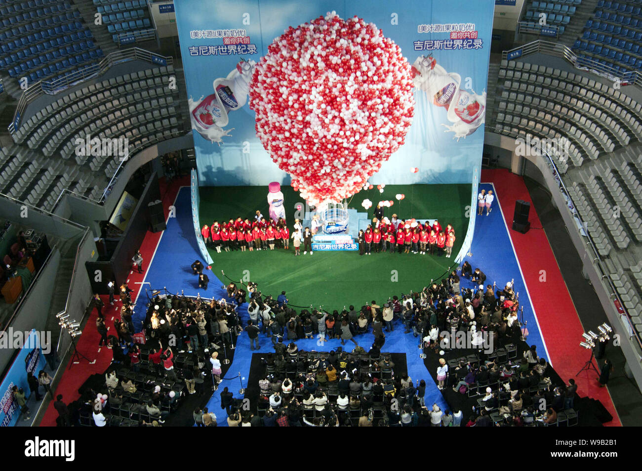 Visitors look at the largest helium balloon cluster during a ceremony ...