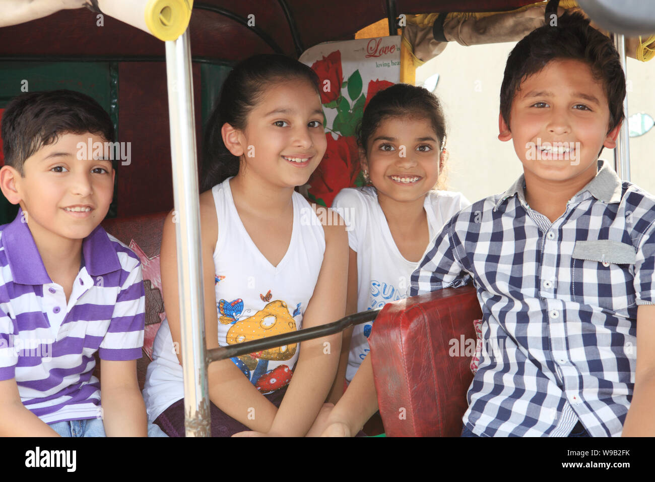 Group of children sitting in an auto rickshaw Stock Photo - Alamy
