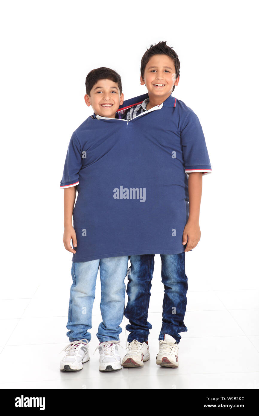 Two young boys wearing the same polo shirt Stock Photo - Alamy