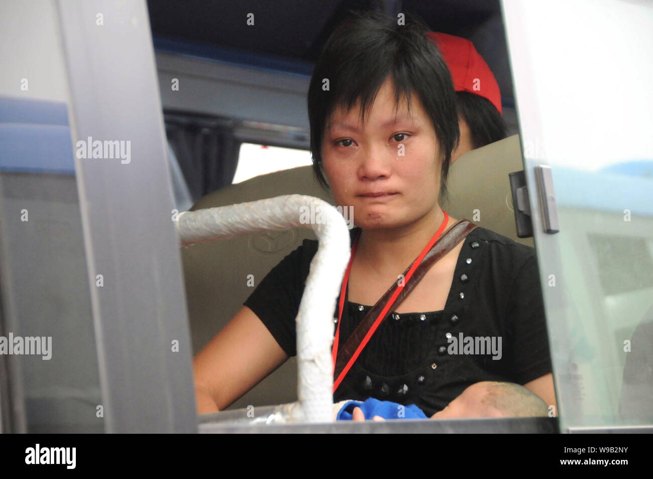A young Chinese woman weeps on her leaving of her hometown before ...
