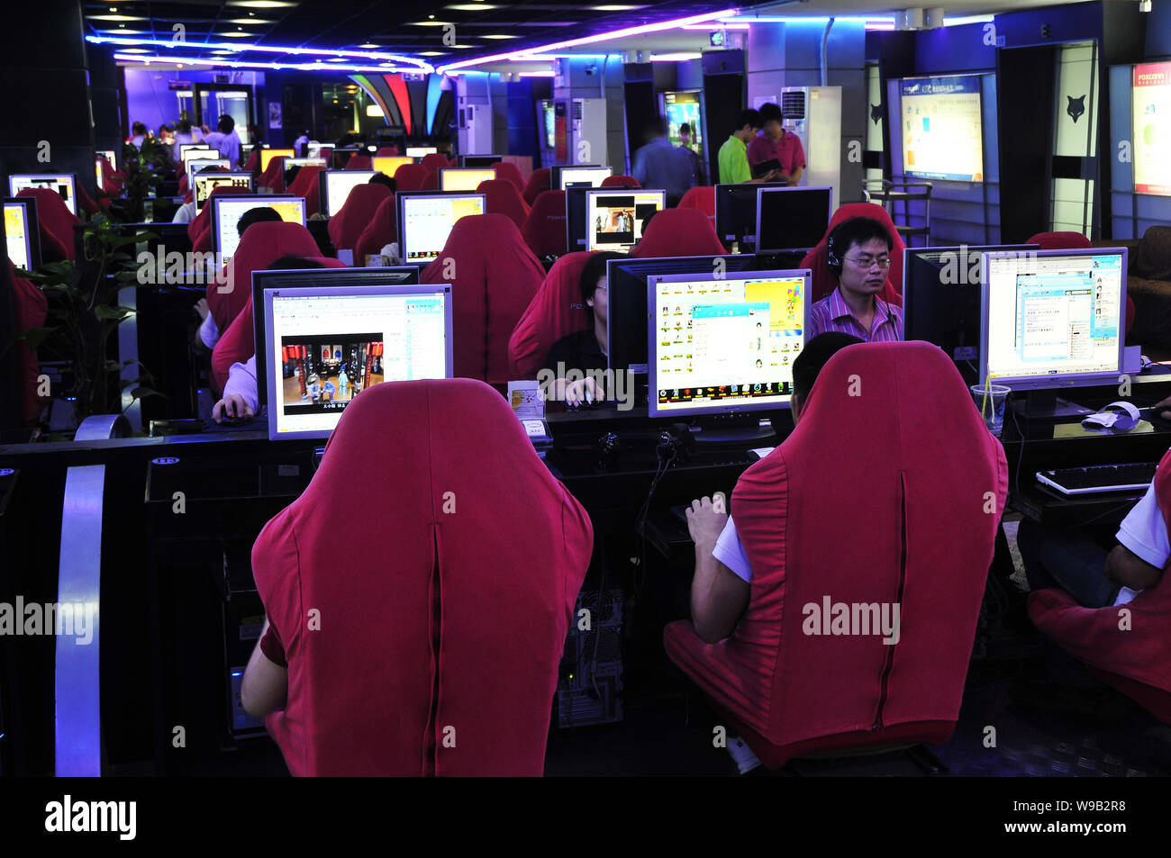 Chinese Foxconn employees surf the Internet at an Internet cafe at the ...