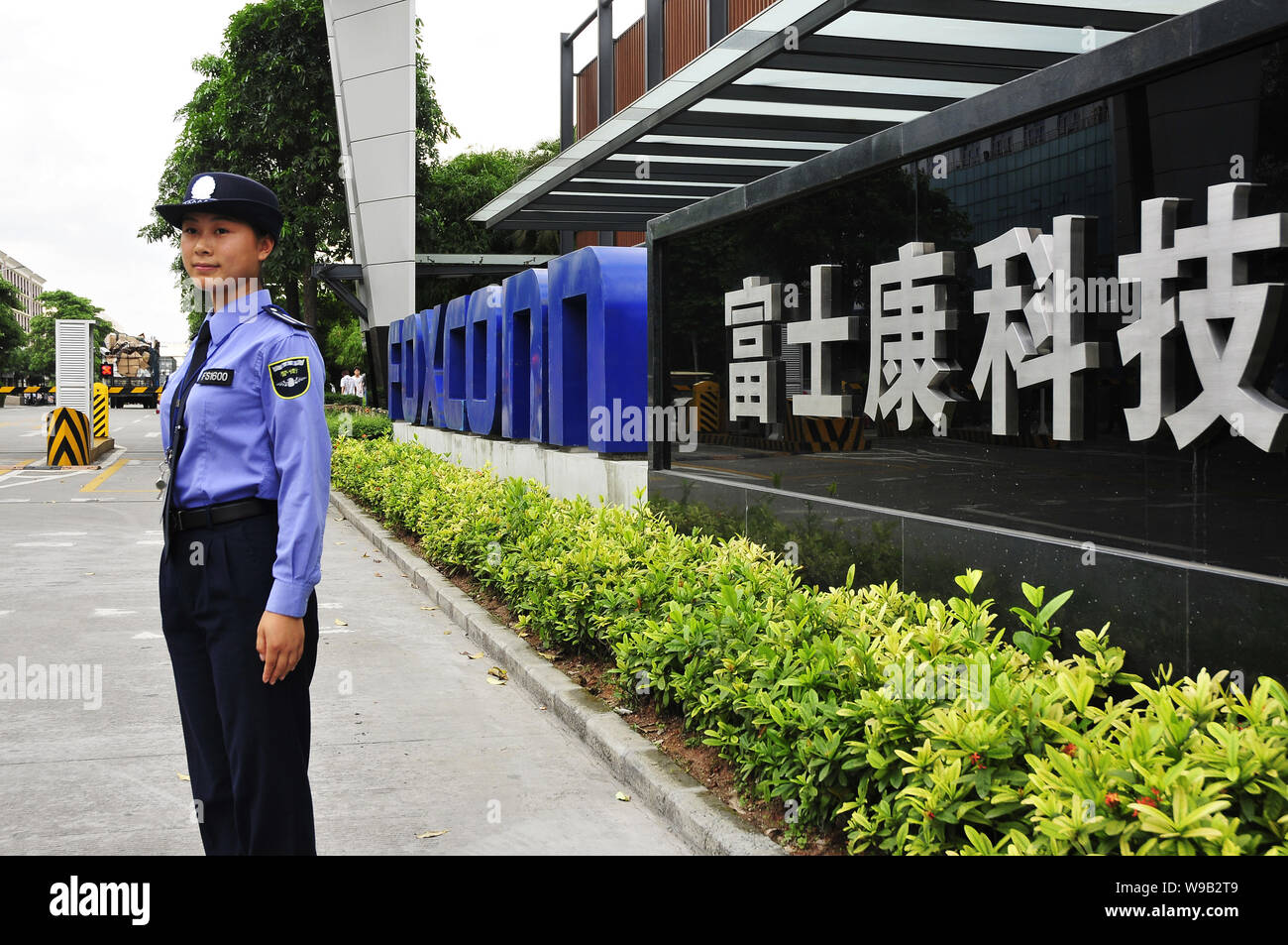 A female Chinese security stands guard at the south entrance of the ...
