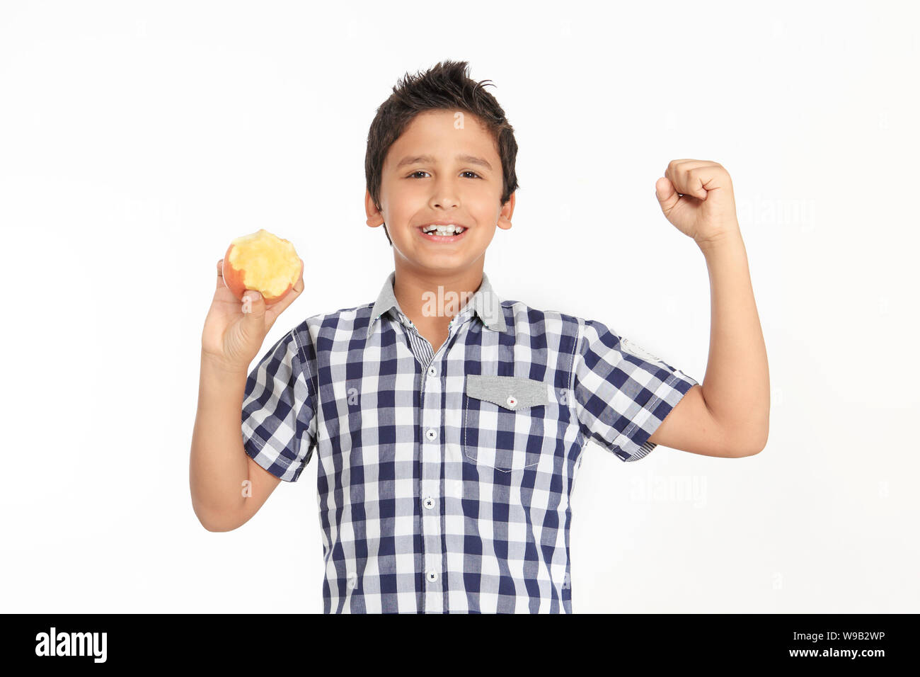 Boy eating an apple and smiling Stock Photo - Alamy