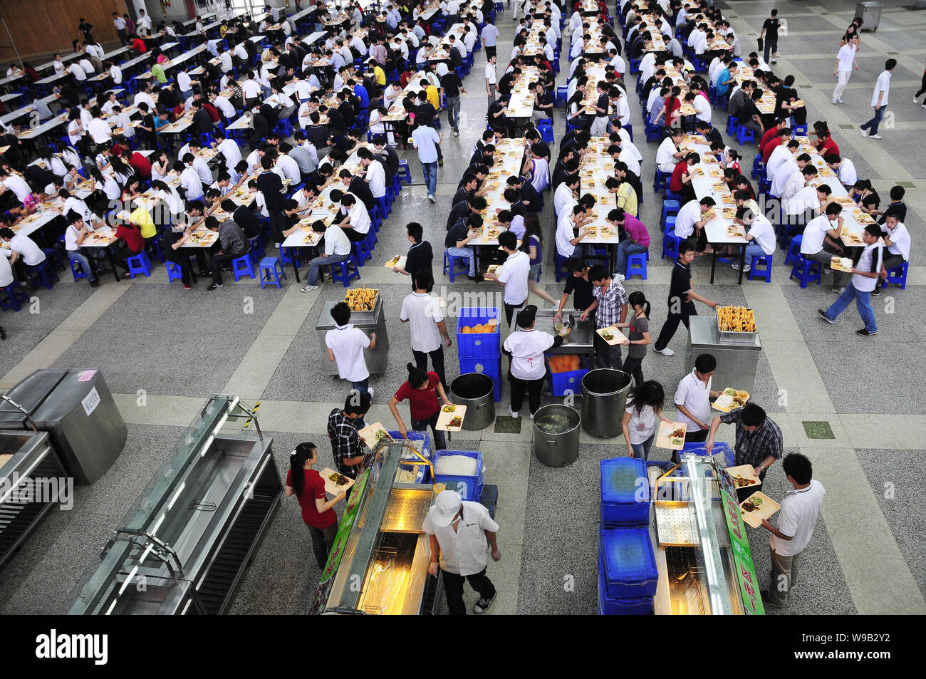 Chinese Foxconn employees have lunch in a dining hall at the Shenzhen ...
