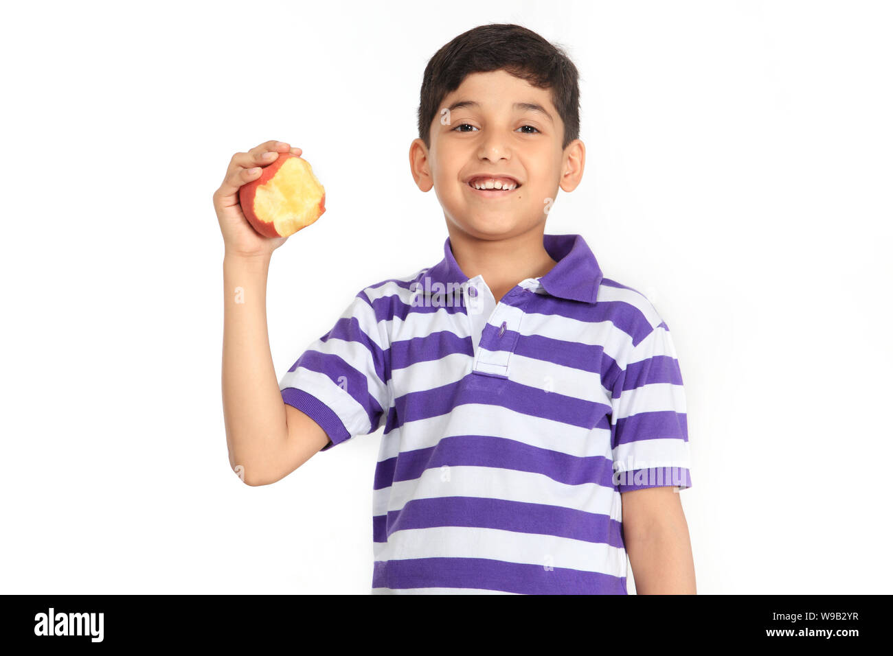 Boy eating an apple and smiling Stock Photo - Alamy