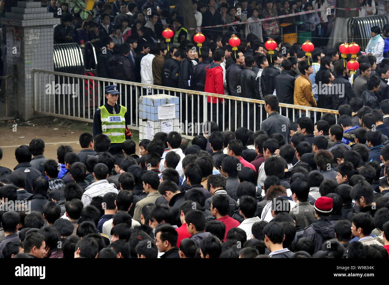 Crowds of job seekers queue up to apply for jobs during a recruitment ...