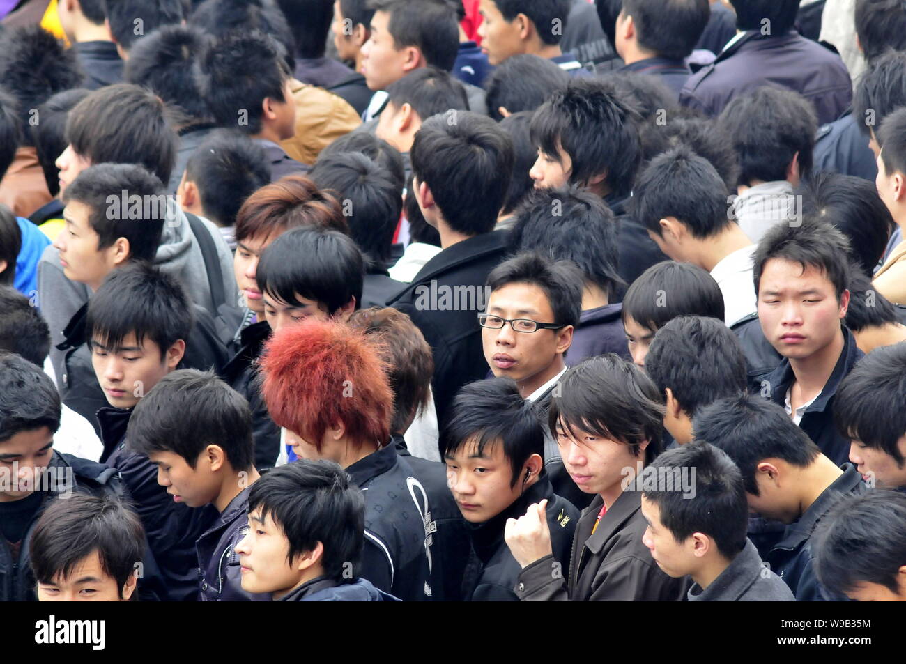 Crowds of job seekers queue up to apply for jobs during a recruitment ...