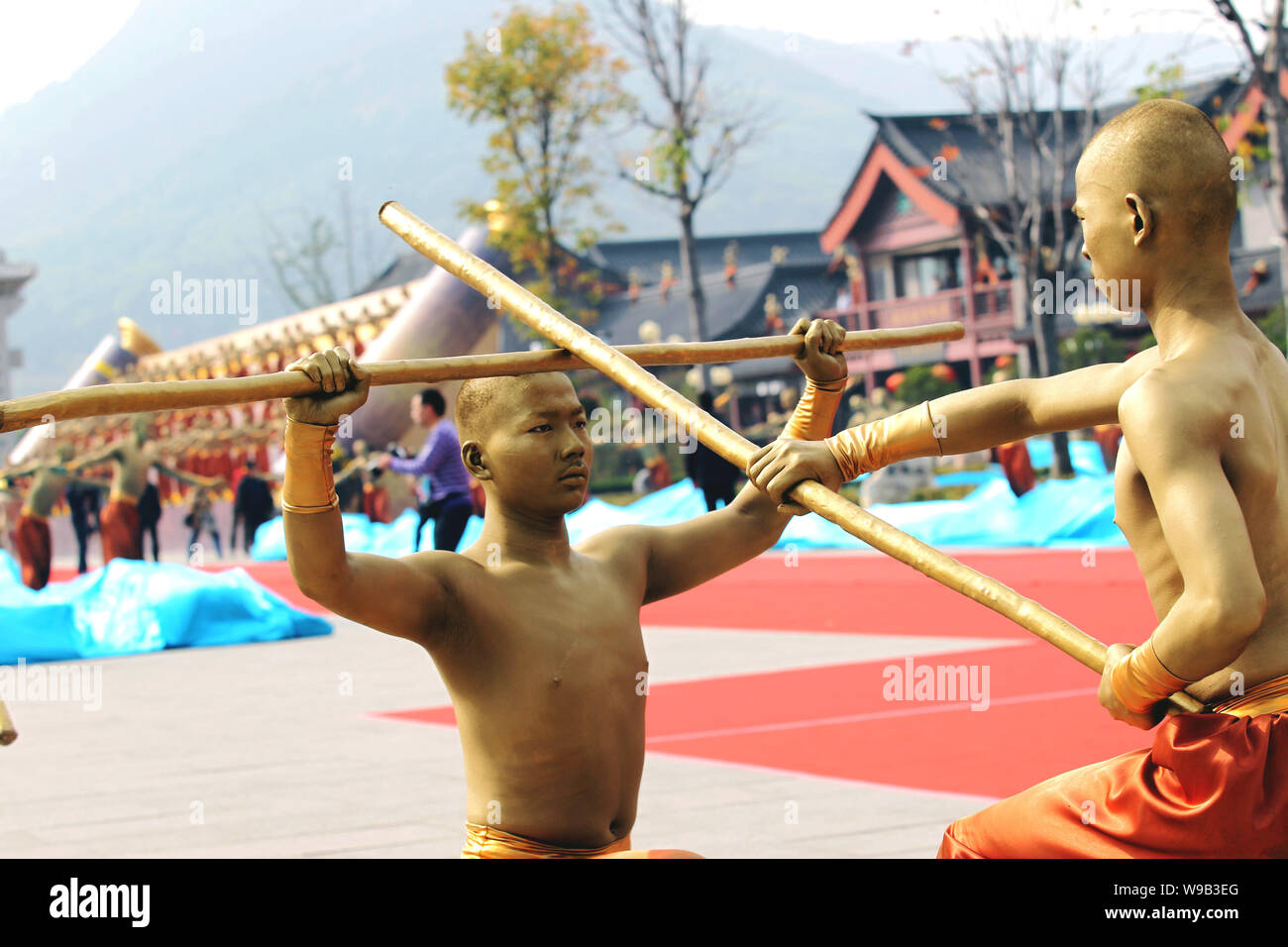 Chinese monks painted in bronze perform Shaolin kung fu during the 8th ...