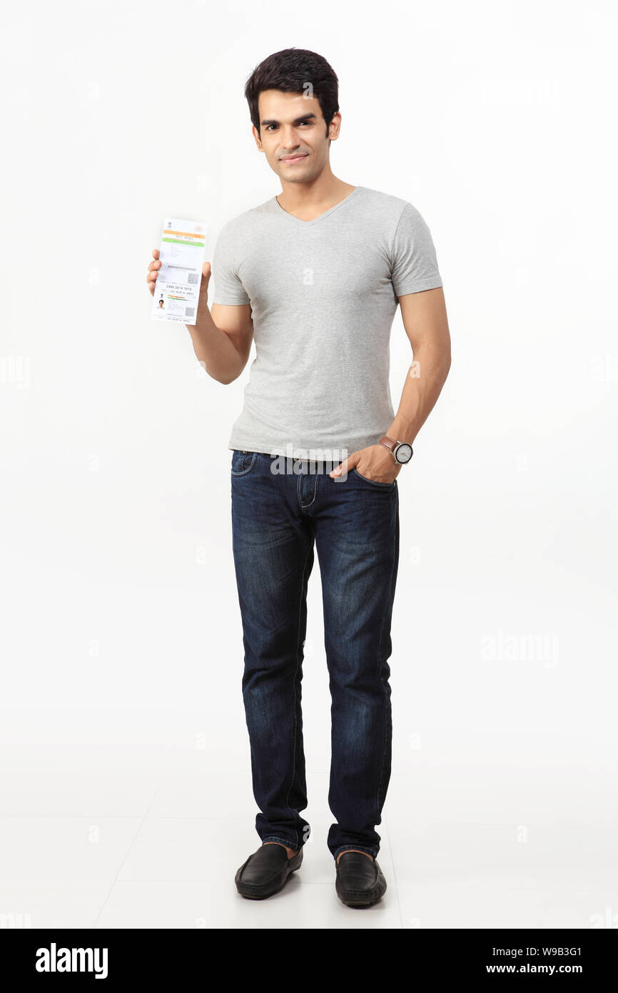 Young man standing and showing an Aadhar card Stock Photo - Alamy