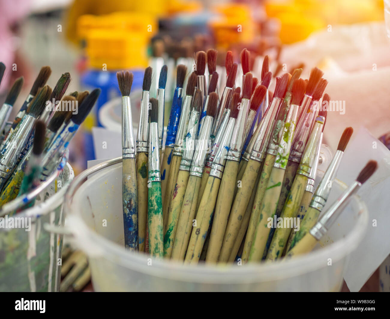 Artist paint brushes. Many artist tools in plastic bucket, art ...