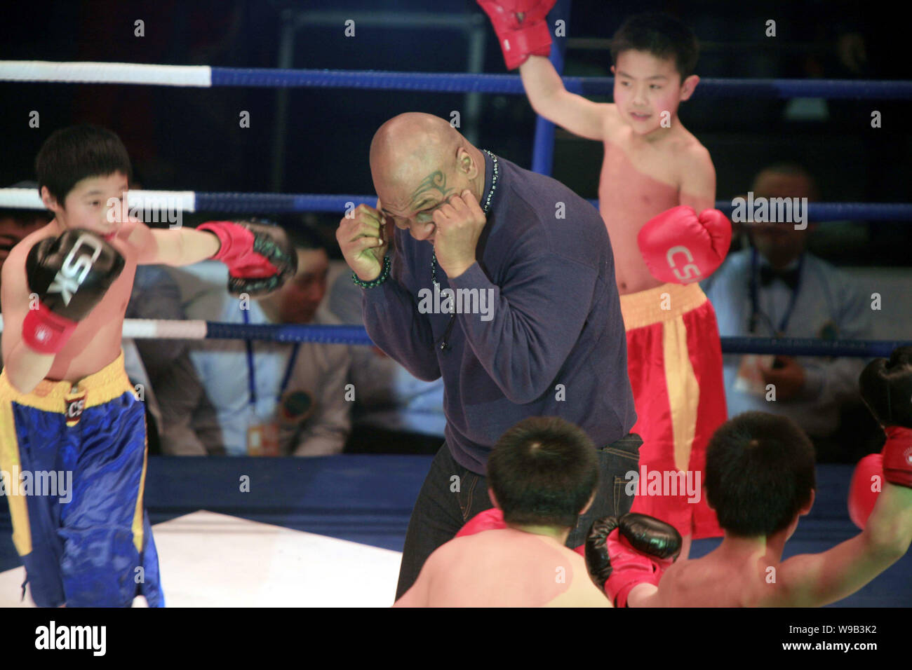 U.S. boxer Mike Tyson interacts with young boxers during the First ...