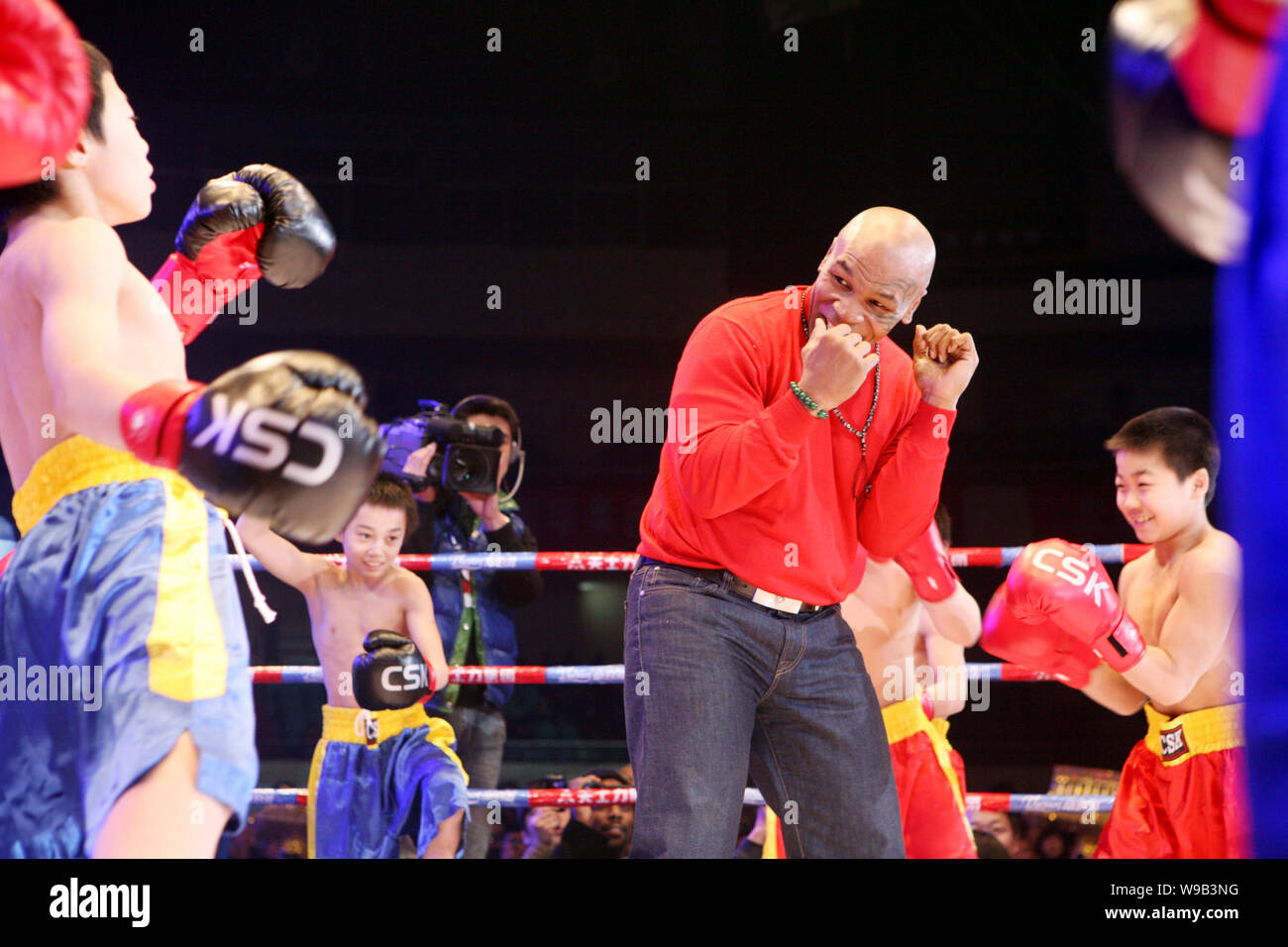 U.S. boxer Mike Tyson interacts with young boxers during the First ...