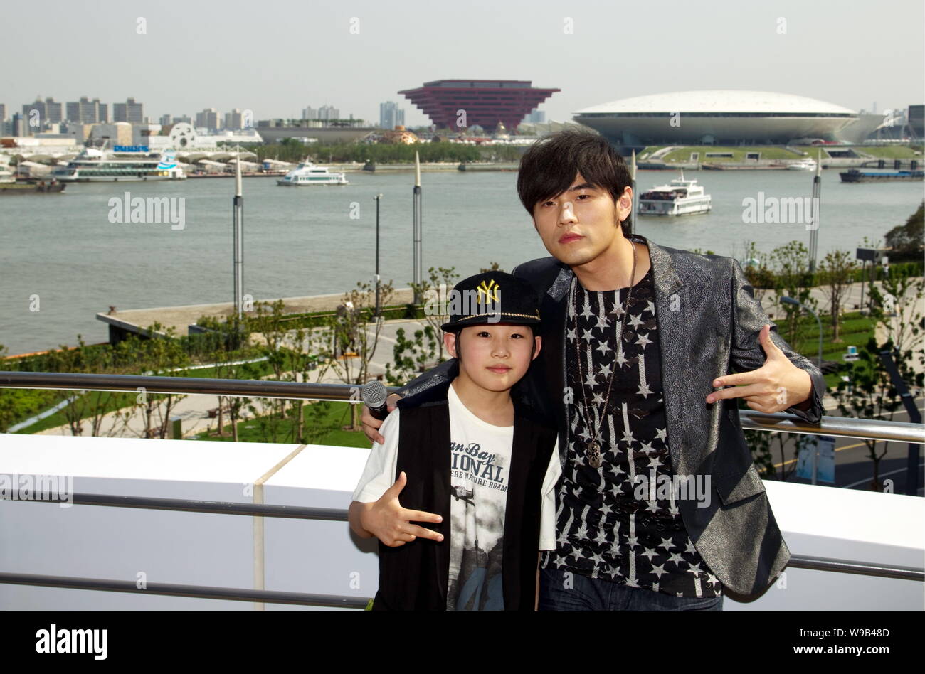 Taiwanese singer and actor Jay Chou, right, poses with Chinese child ...