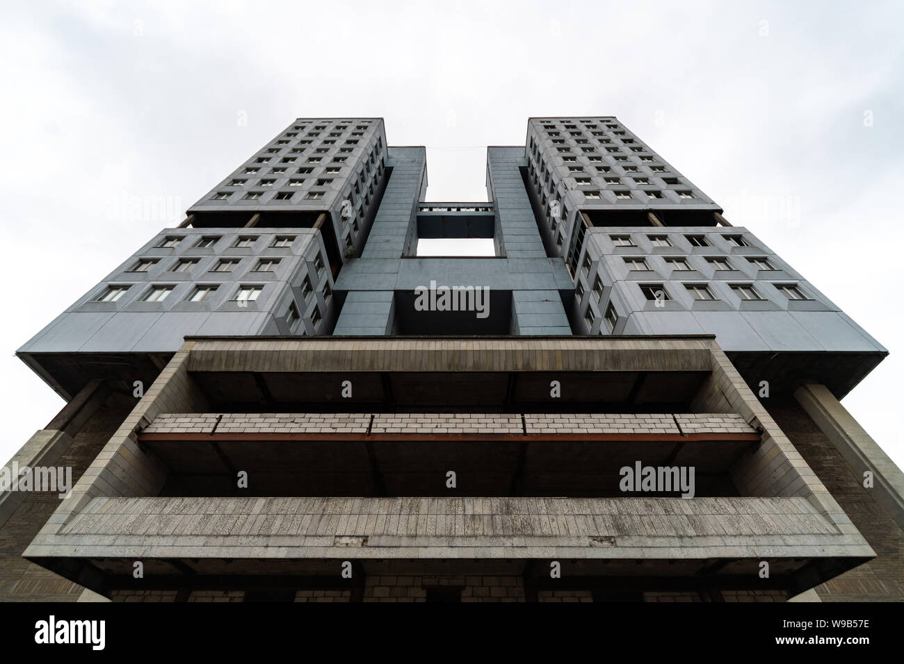 Abandoned high-rise building, cloudy weather, copy space. Unfinished ...
