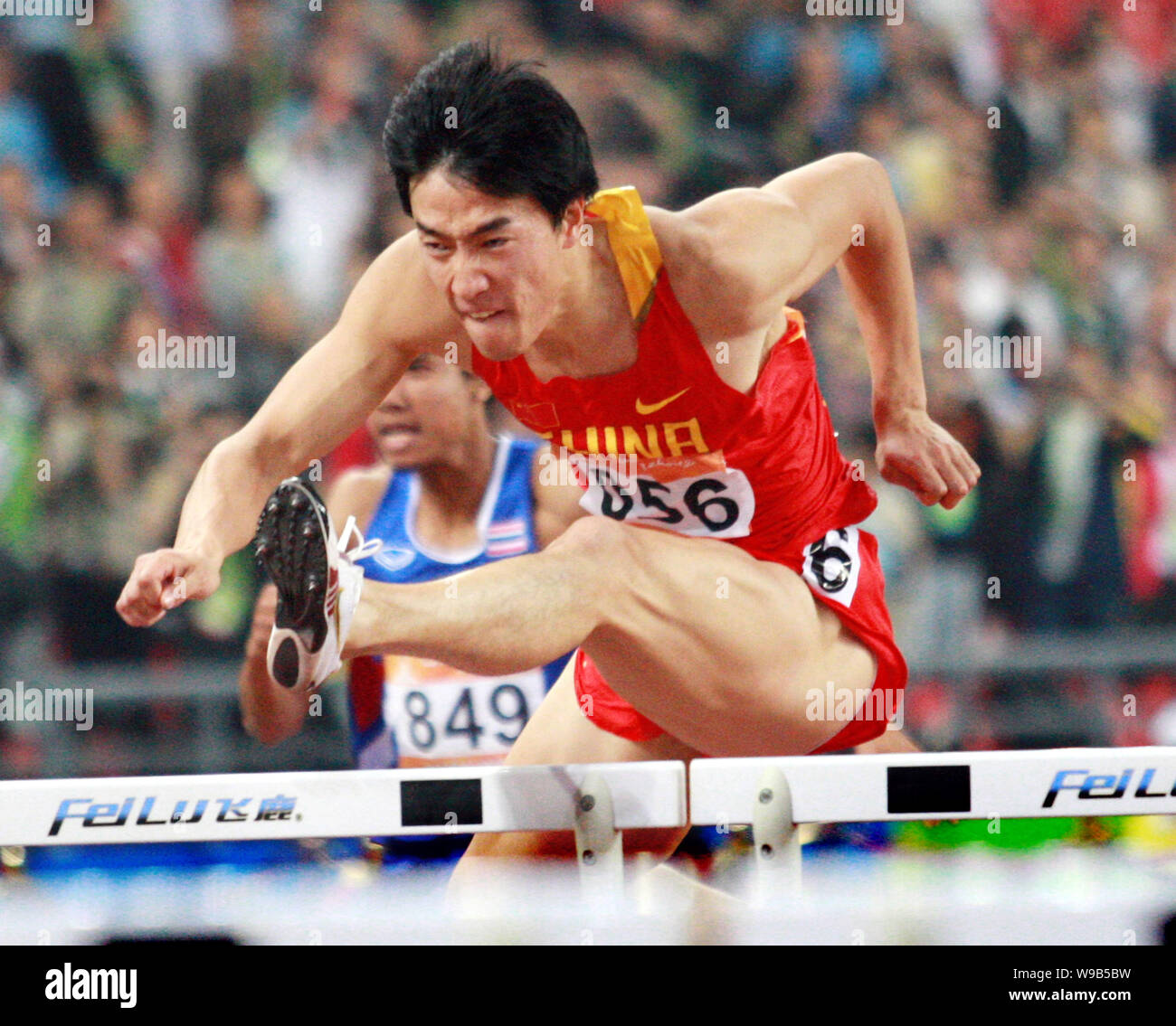 Chinas star hurdler Liu Xiang, front, clears a hurdle in the mens 110m ...