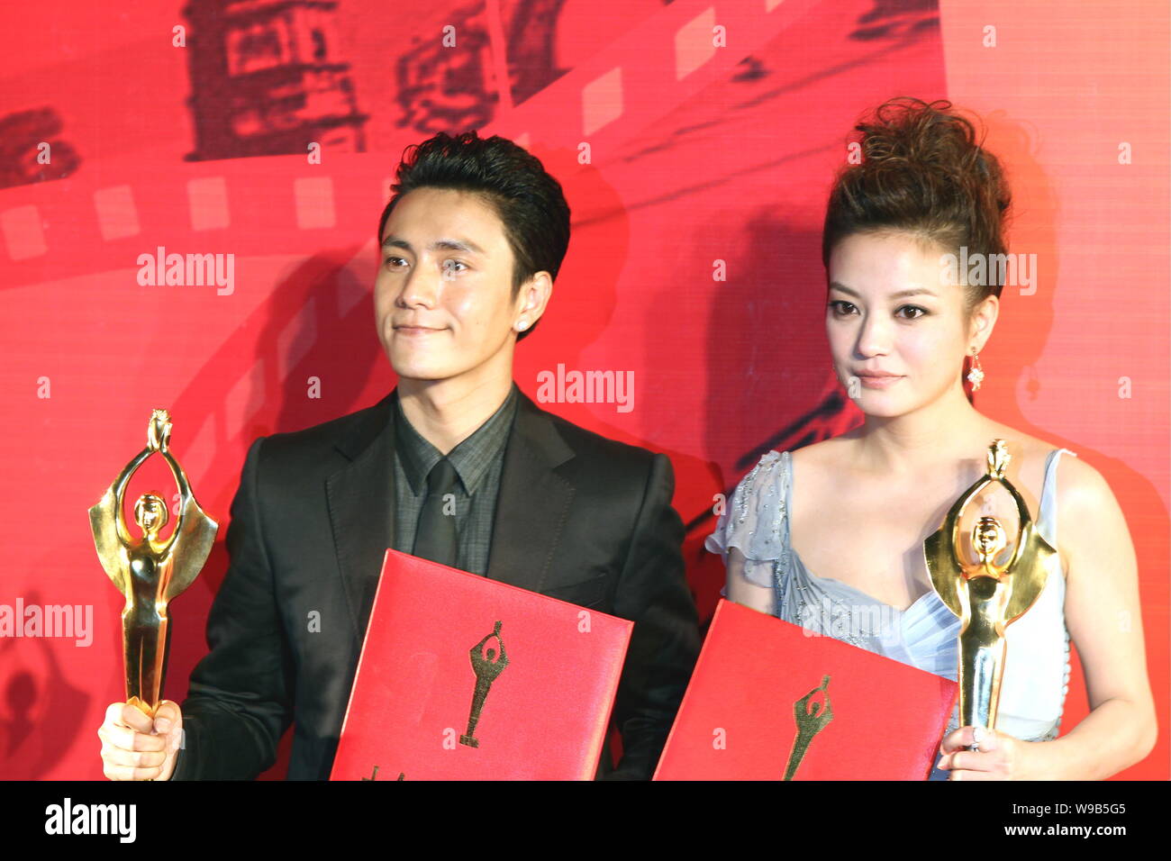 Chinese actress Zhao Wei (right) and actor Chen Kun pose with trophies ...