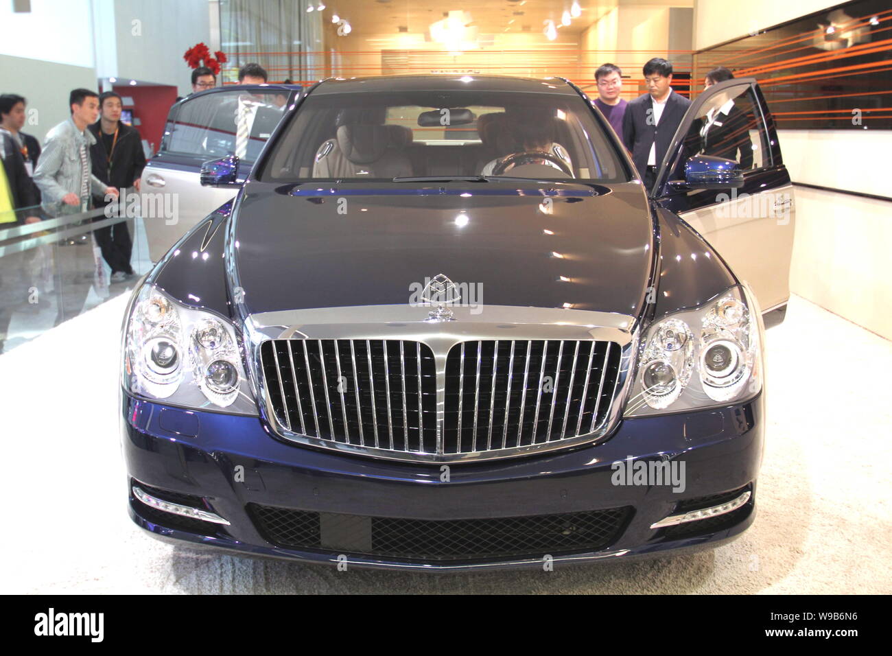 Chinese buyers look at a Maybach 62 during an auto show in Beijing ...
