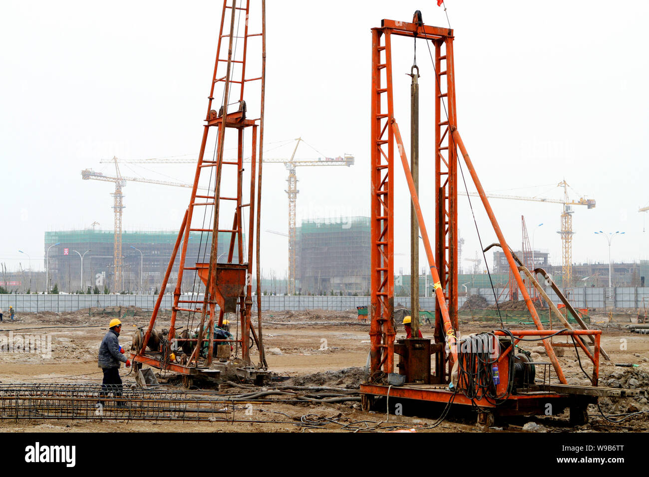 Chinese workers labor on a construction site in the Sino-Singapore ...