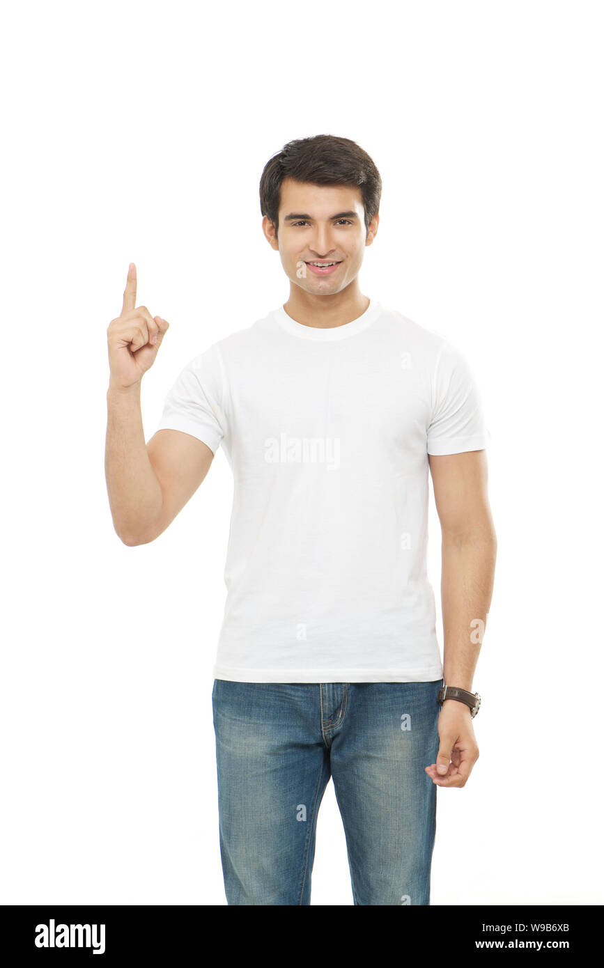 Young man pointing upward Stock Photo - Alamy