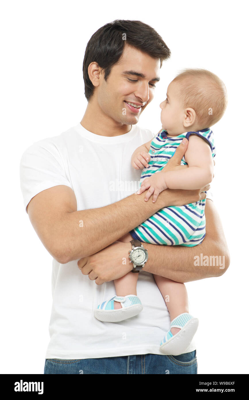 Young man carrying his baby Stock Photo - Alamy