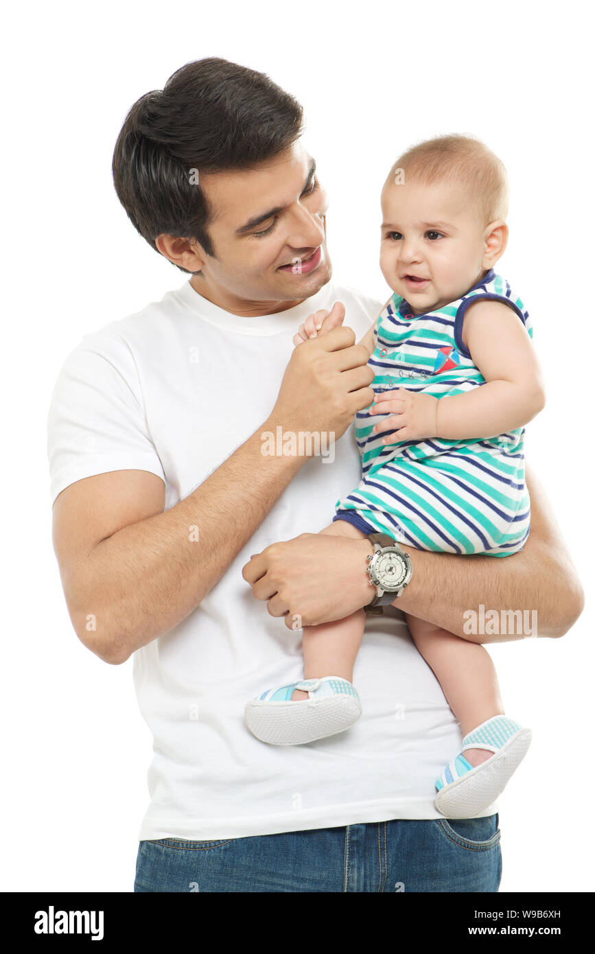 Young man carrying his baby Stock Photo - Alamy
