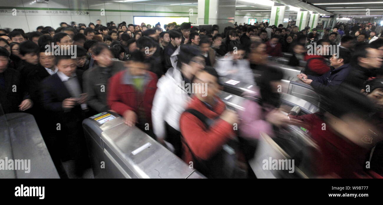 --FILE--Chinese commuters and passengers crowd the exit of a subway ...