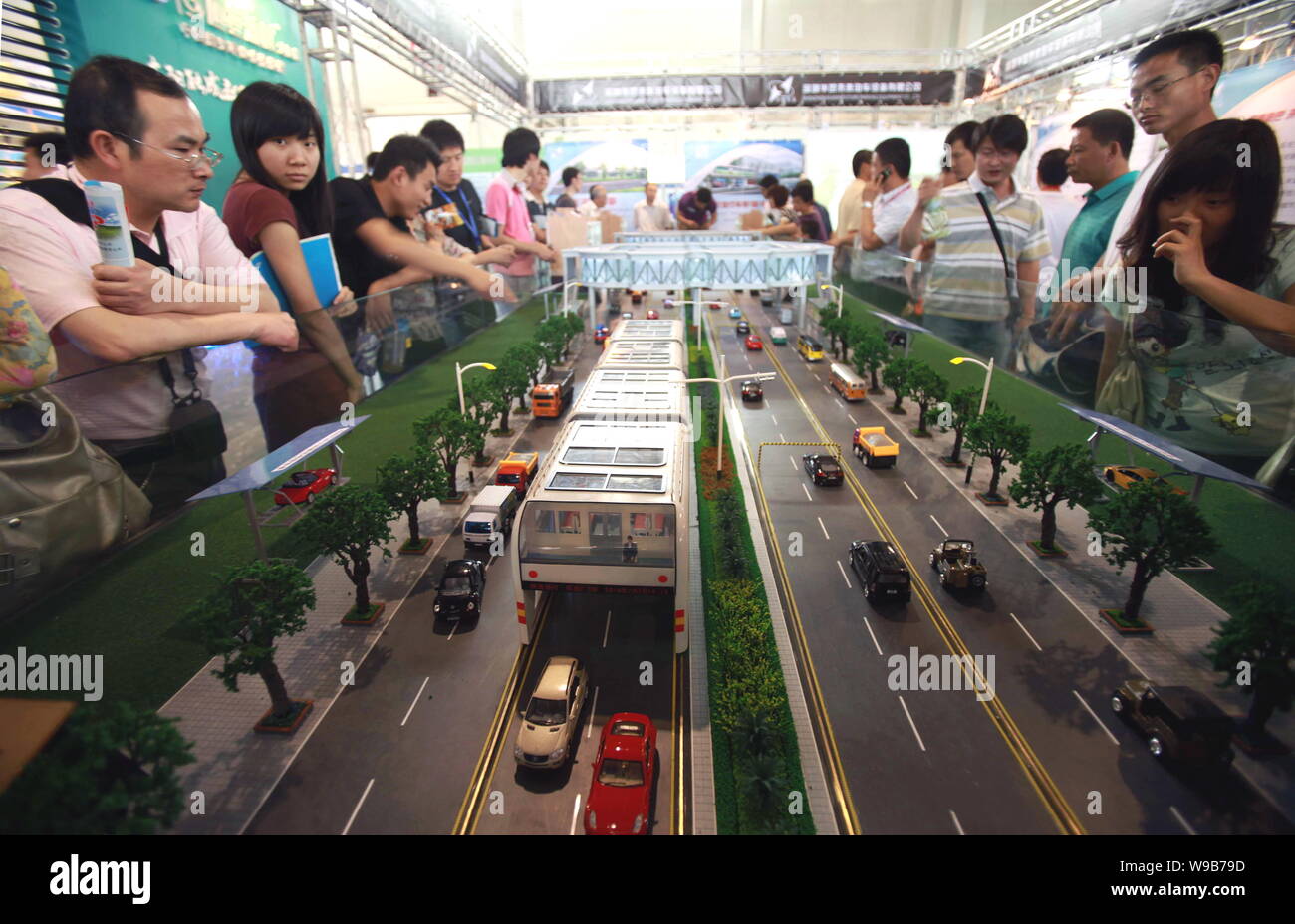 Chinese visitors look at a model of 3D express coach during an ...