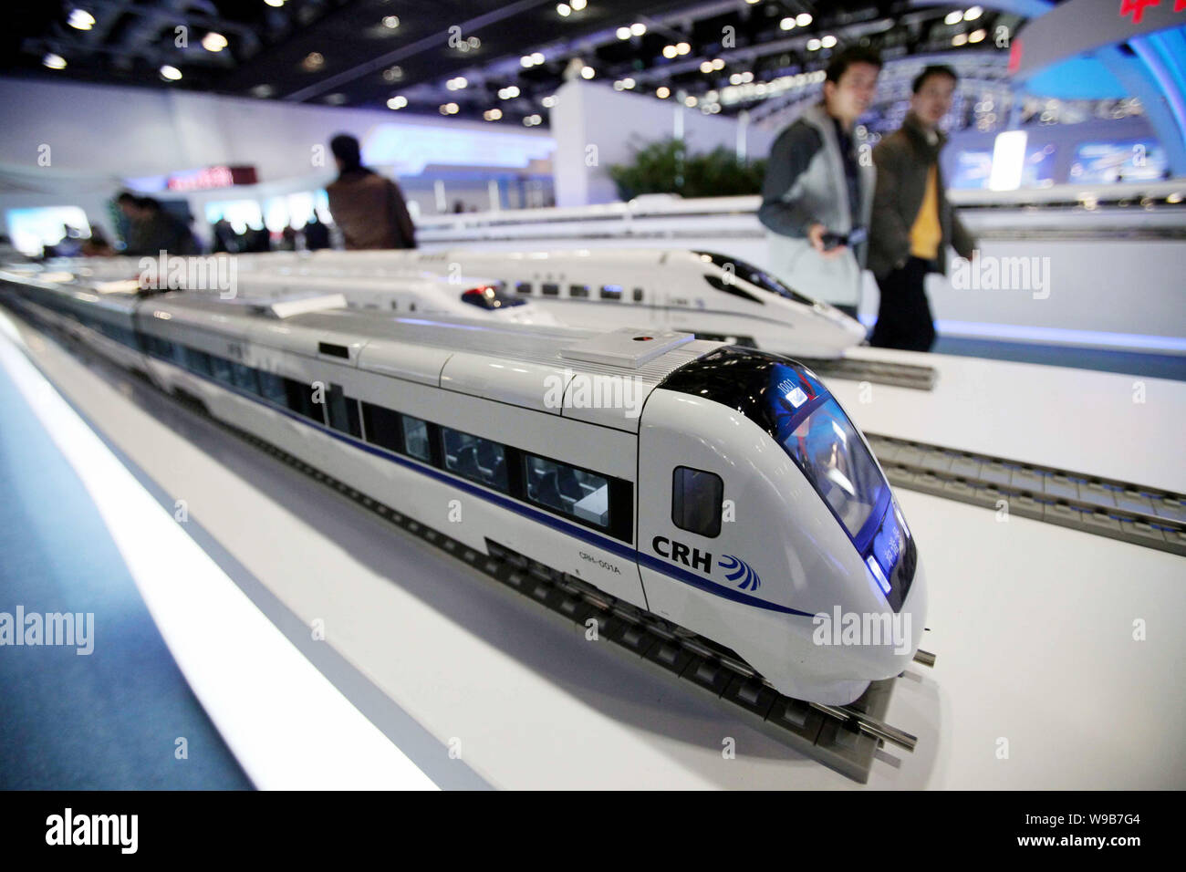 Visitors look at the models of CRH (China Railway High-speed) trains ...
