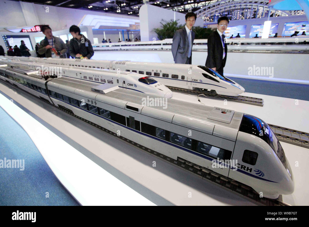 Visitors look at the models of CRH (China Railway High-speed) trains ...