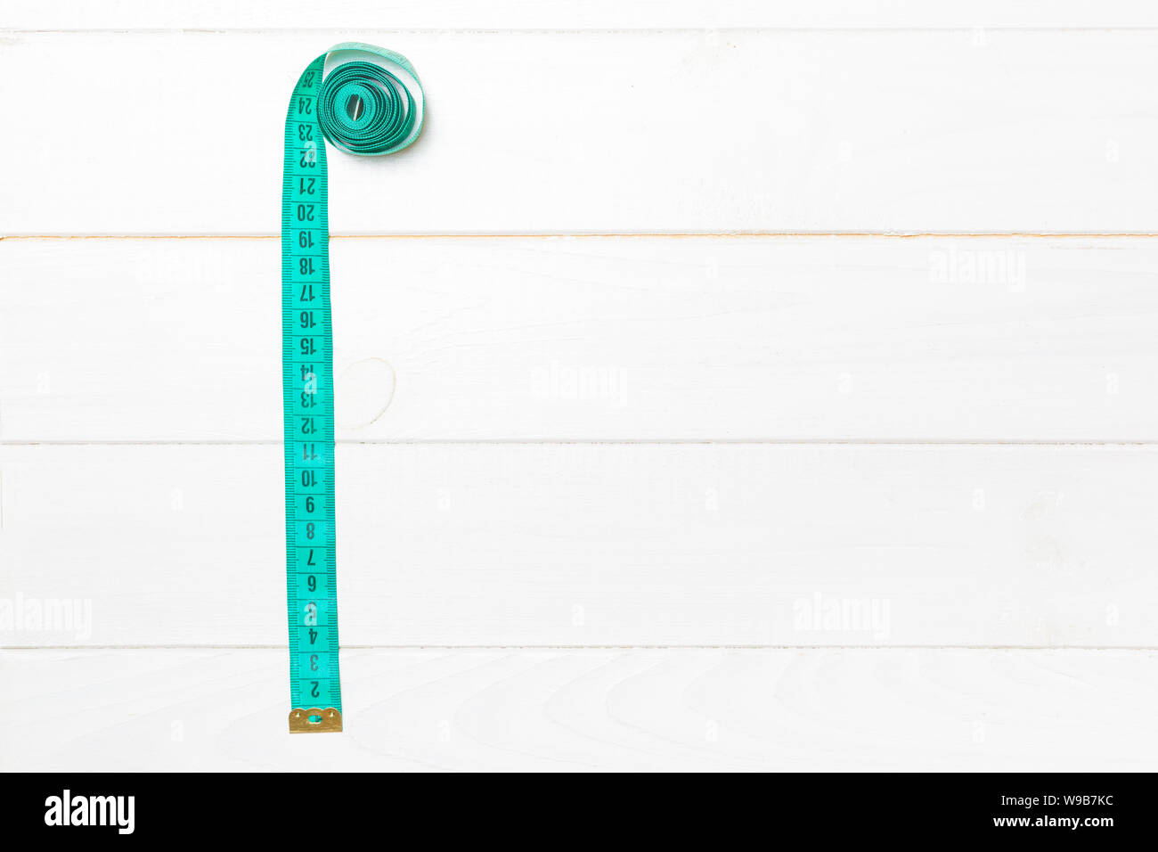 Top view of measure tape in the form of frame on wooden background ...