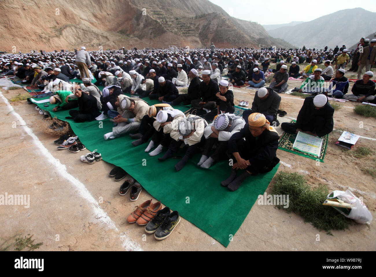 Chinese Muslims attend a prayer session during the Eid al-Fitr on the ...