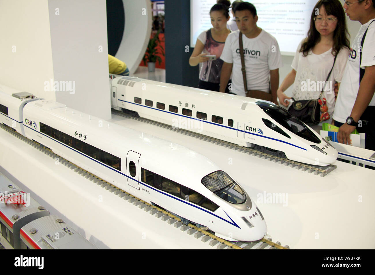 Chinese visitors look at model CRH (China Railway High-speed) trains ...