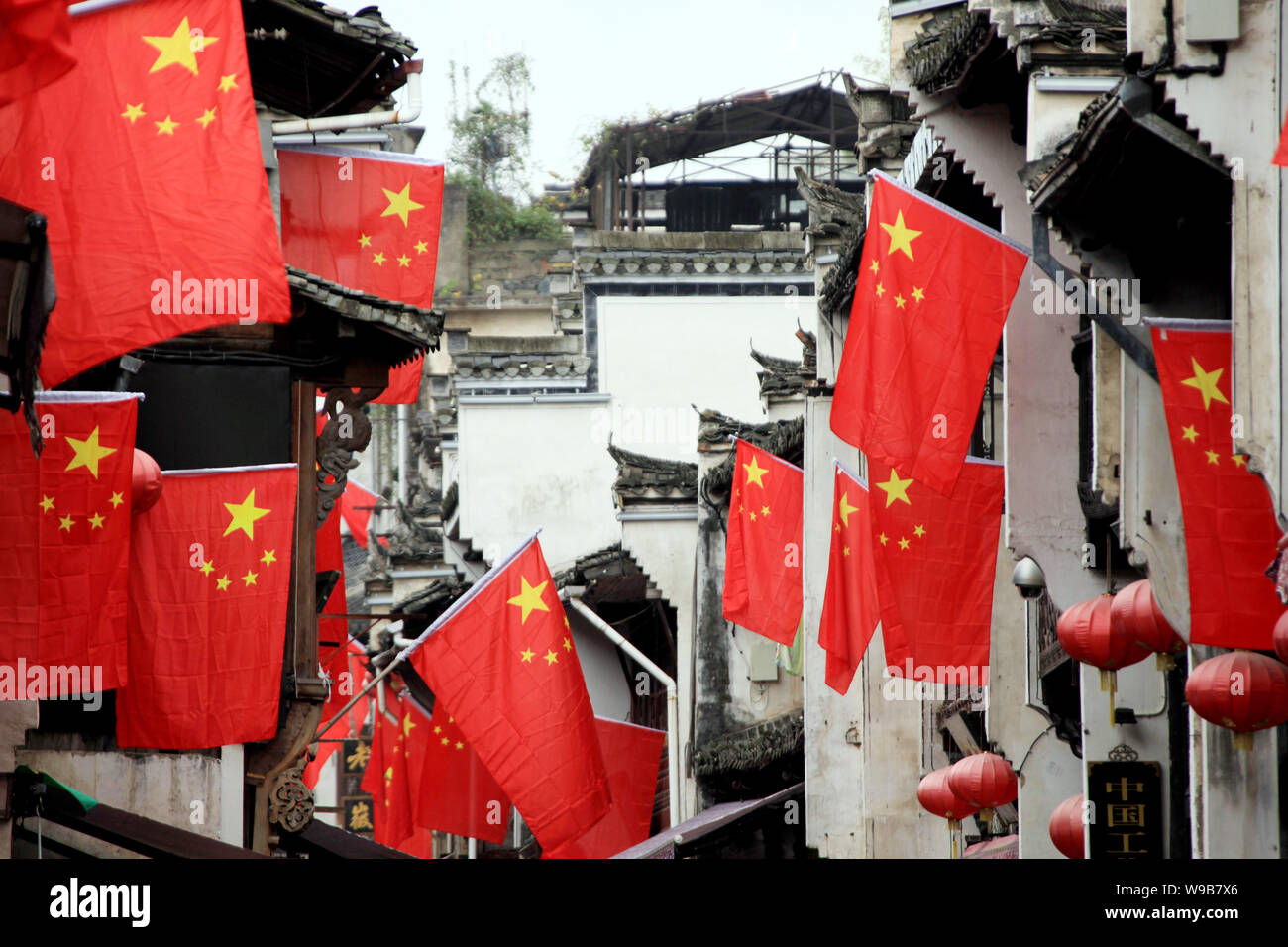Chinese national flags are seen hung up on the houses for the National ...