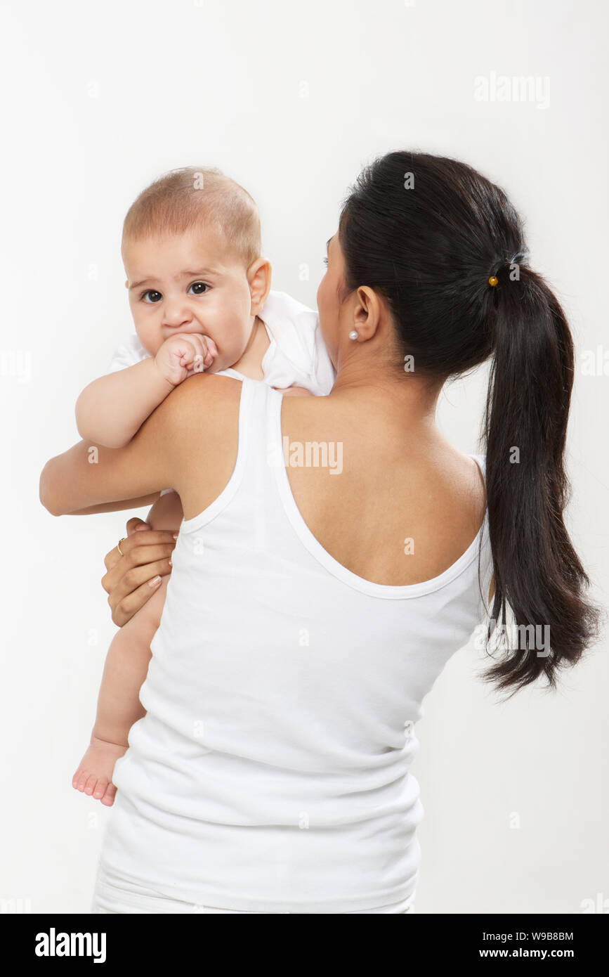 Mother carrying her baby Stock Photo - Alamy